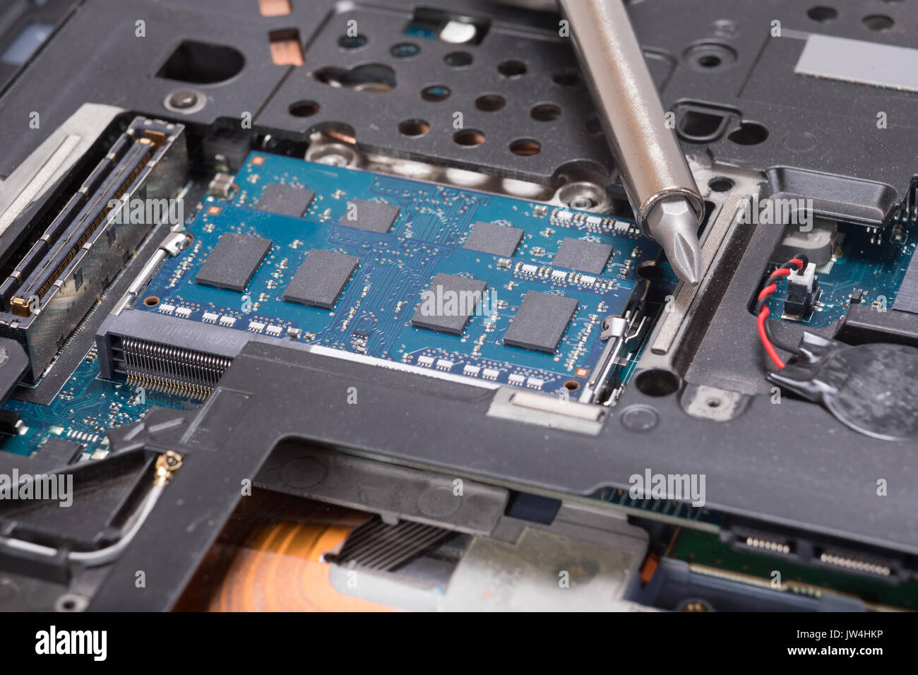 Close up of a screwdriver and electrical parts and components of a ...