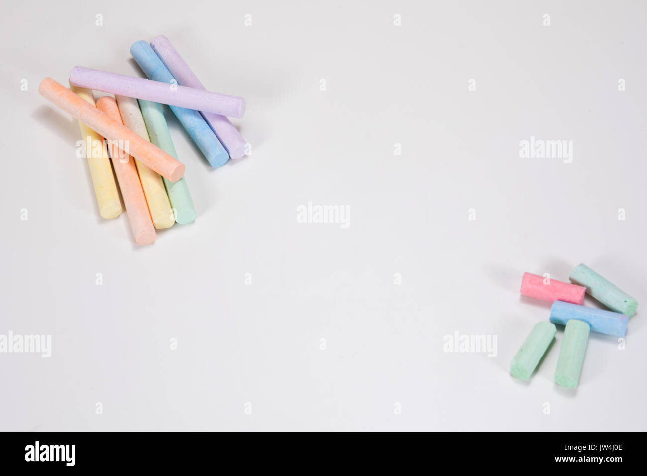 Old, discarded drawing chalk sticks and unused, new sticks in an old ...