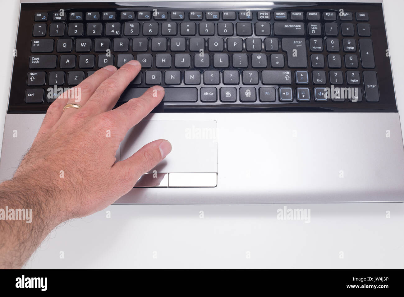 Close up of a mans hand pressing the space bar button on a computer ...