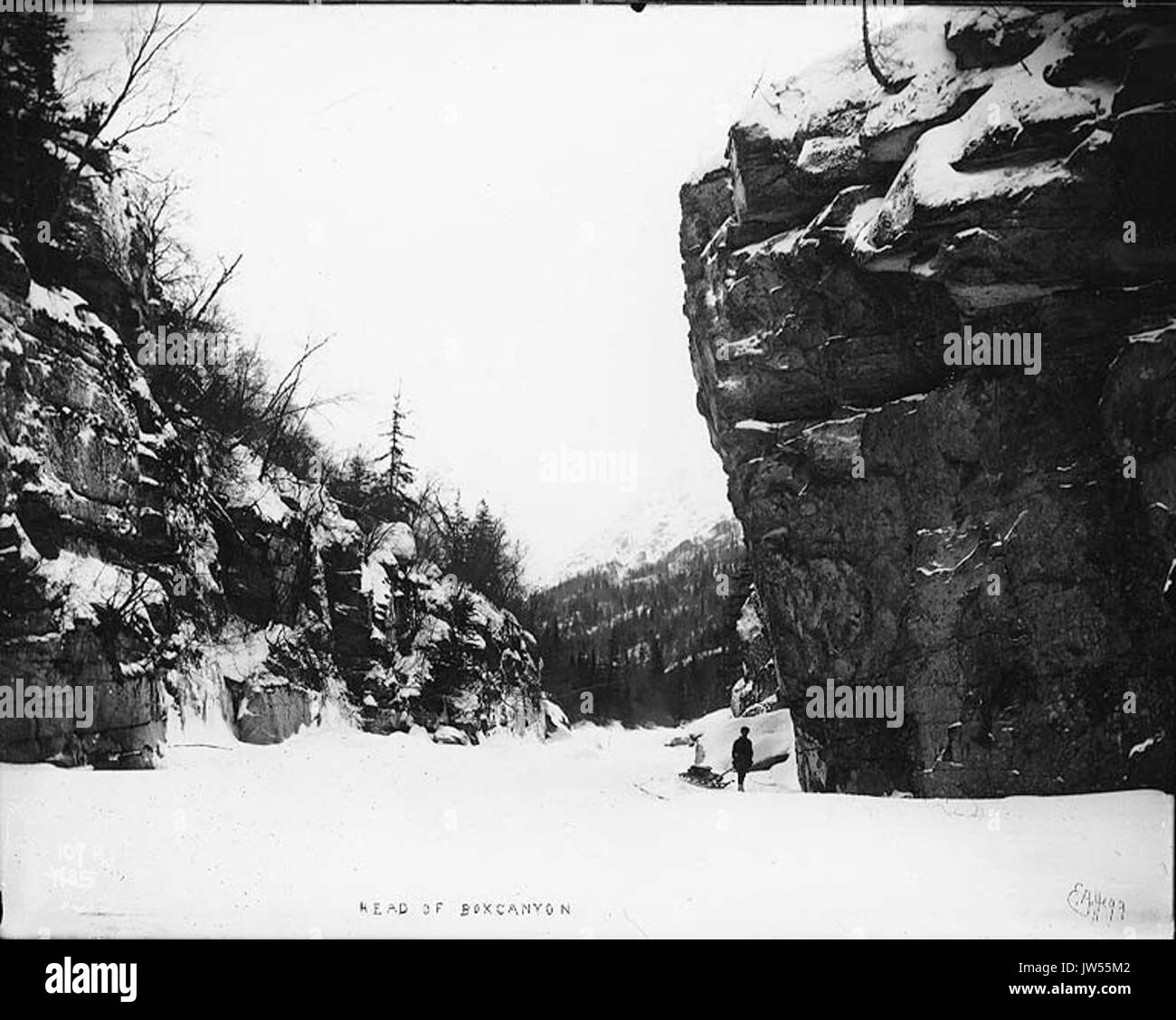 Man hauling sled at the head of Box Canyon on the Skagway River, White ...