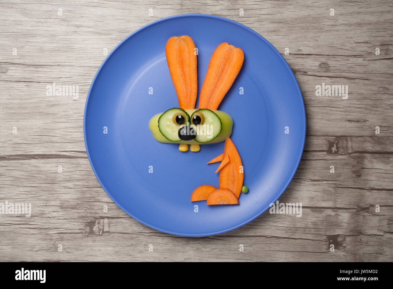 Rabbit made of carrot on plate and table Stock Photo - Alamy