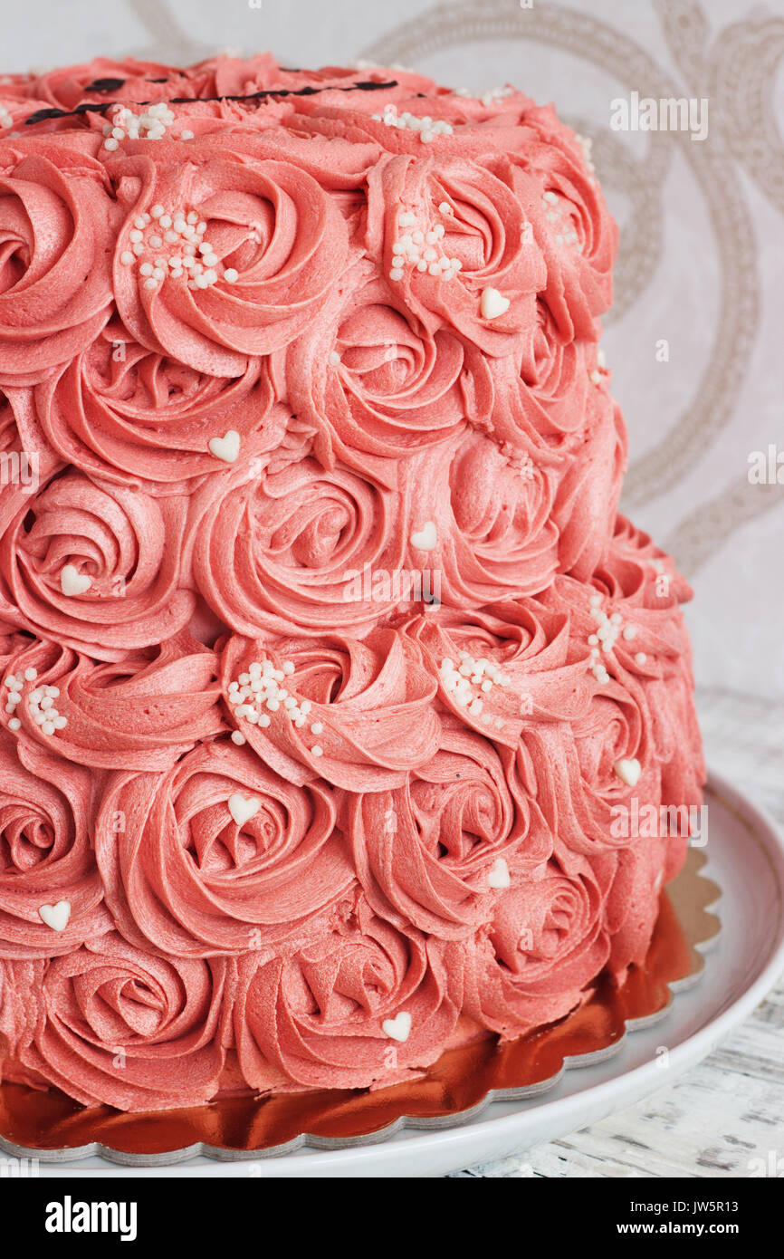 Gorgeous two-tier cake covered in roses made of butter cream icing ...