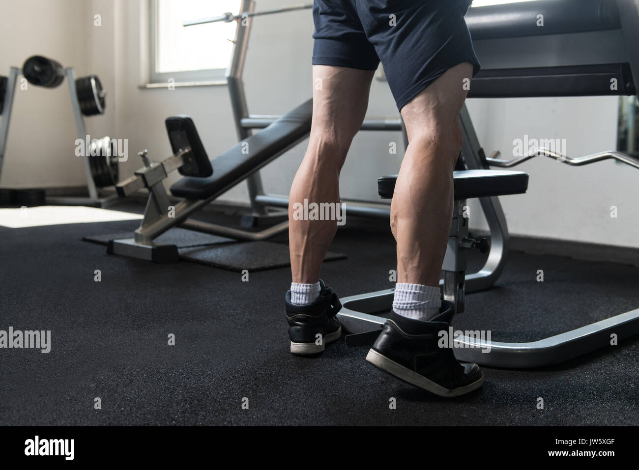 Close Up Of A Bodybuilder Doing Heavy Weight Exercise For Legs Calves ...