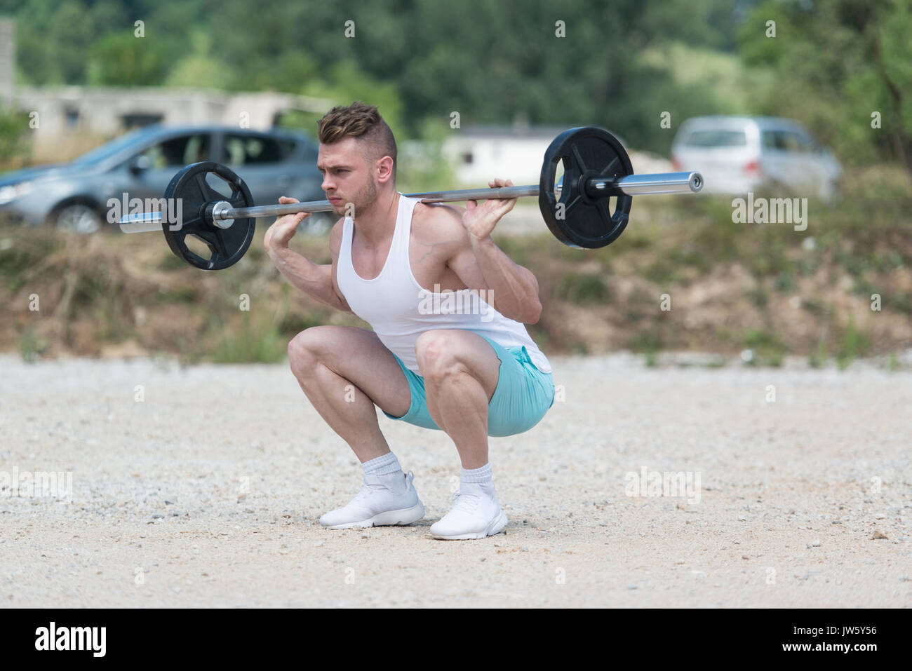 Man Working Out Legs In Outdoors With Barbell Stock Photo - Alamy