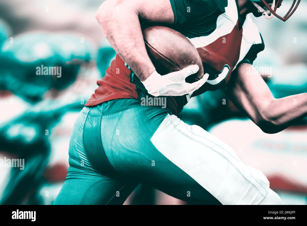 Side view of american football player who runs with the ball to make a ...