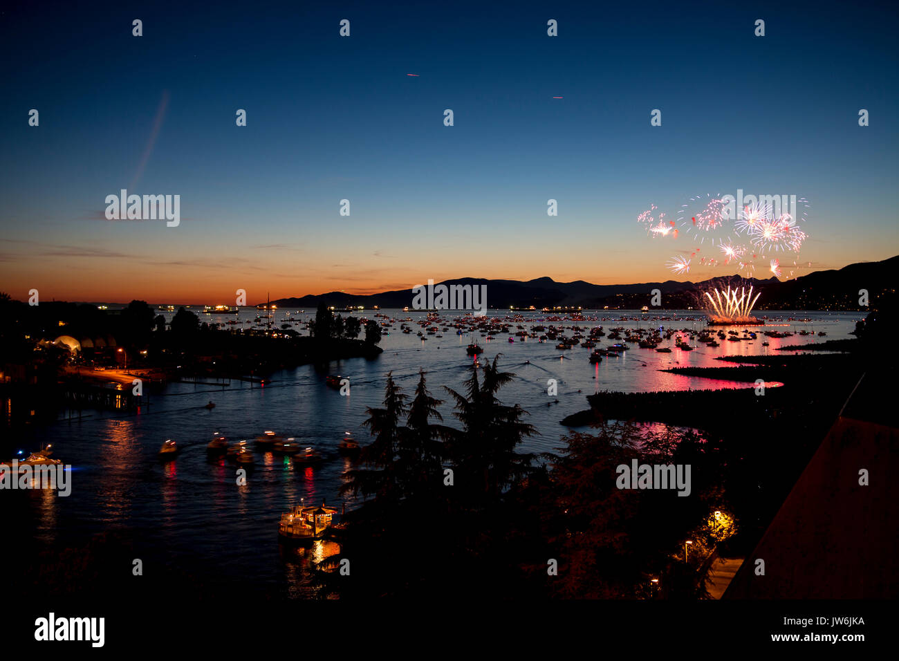 Fireworks being shot up into the evening sky to make a scene with ...