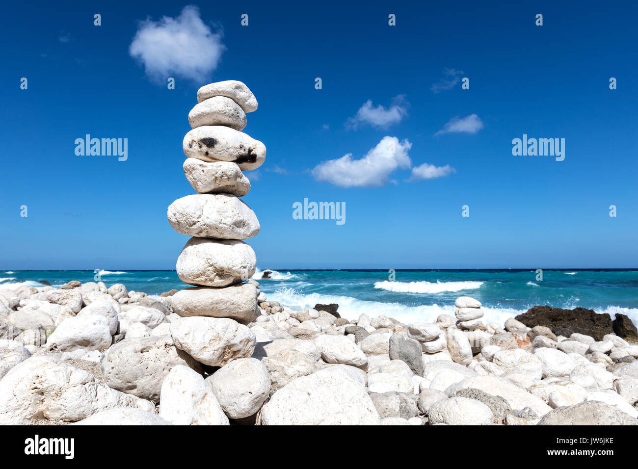 A pyramid of rounded white stones by the sea Stock Photo - Alamy