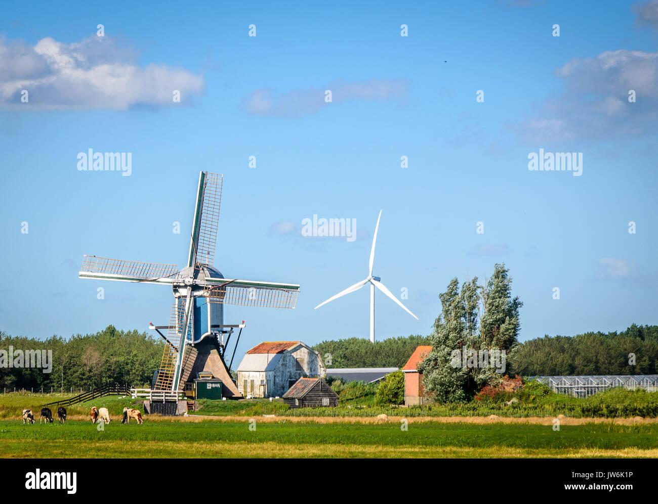 Traditional windmill and wind turbine powered generator, showing how ...