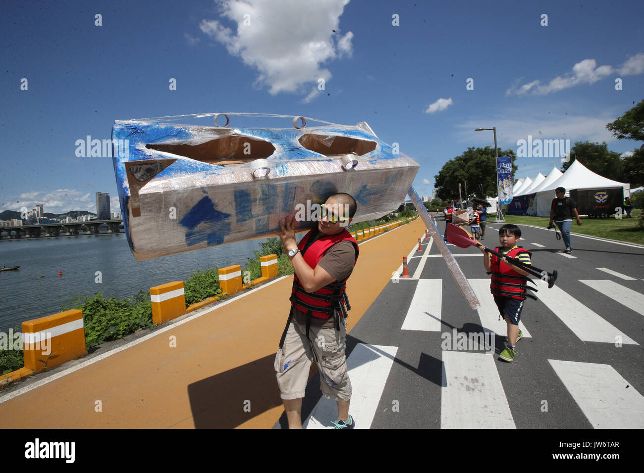 Paper ship-riding contest Participants transport their paper ships to ...