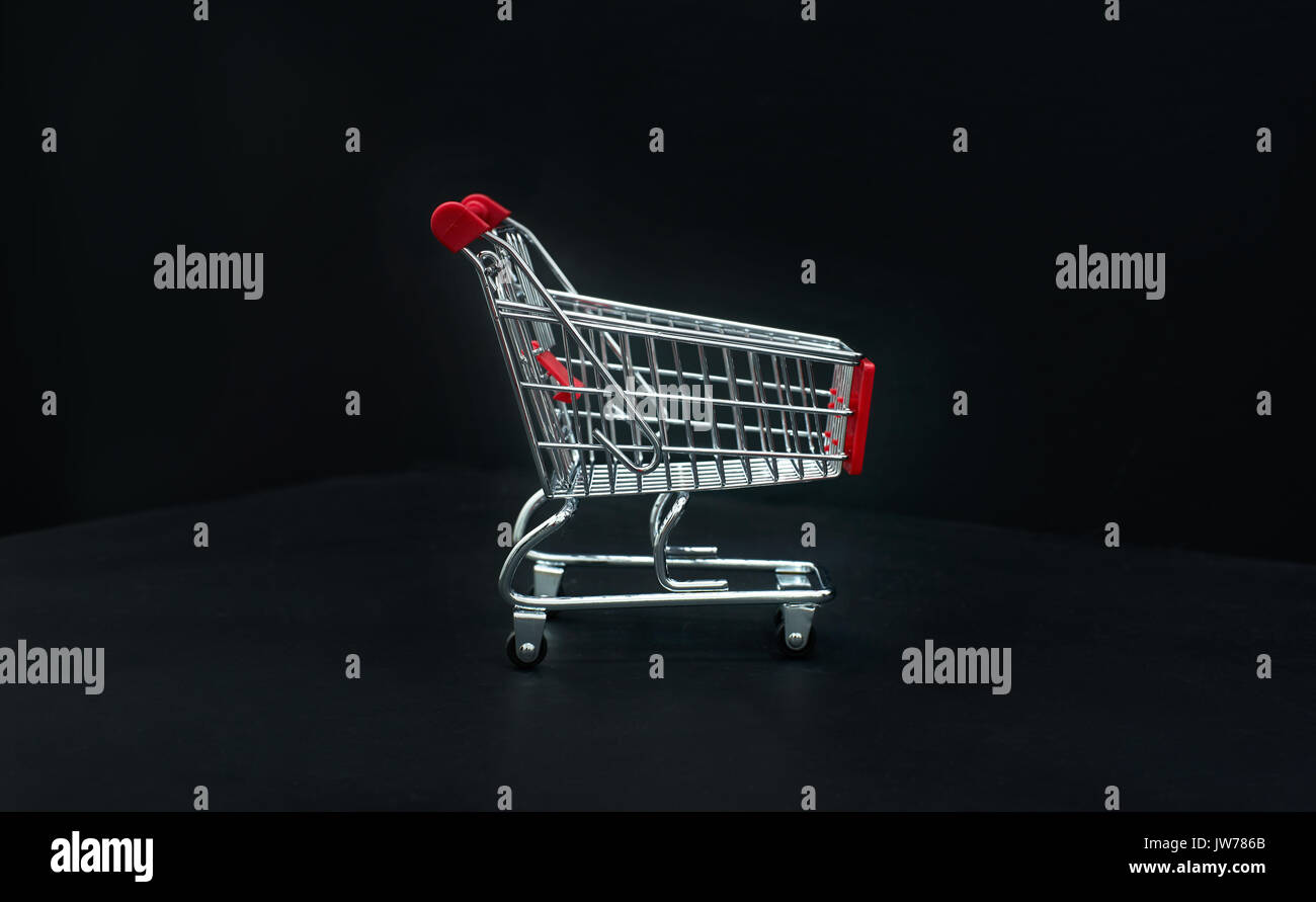 Shopping cart or trolley on black background Stock Photo - Alamy