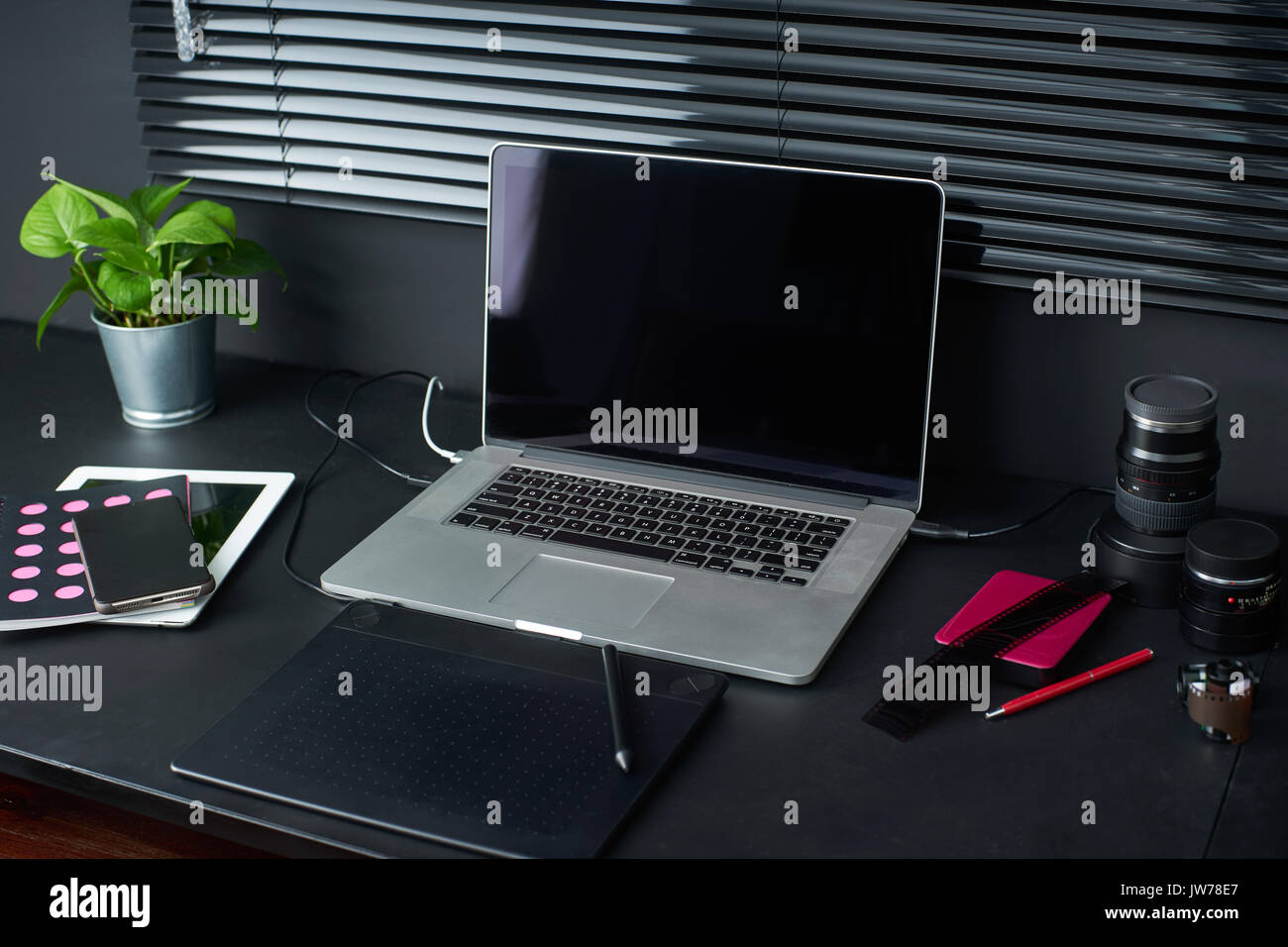 Work space on black table of a photographer or designer with laptop ...