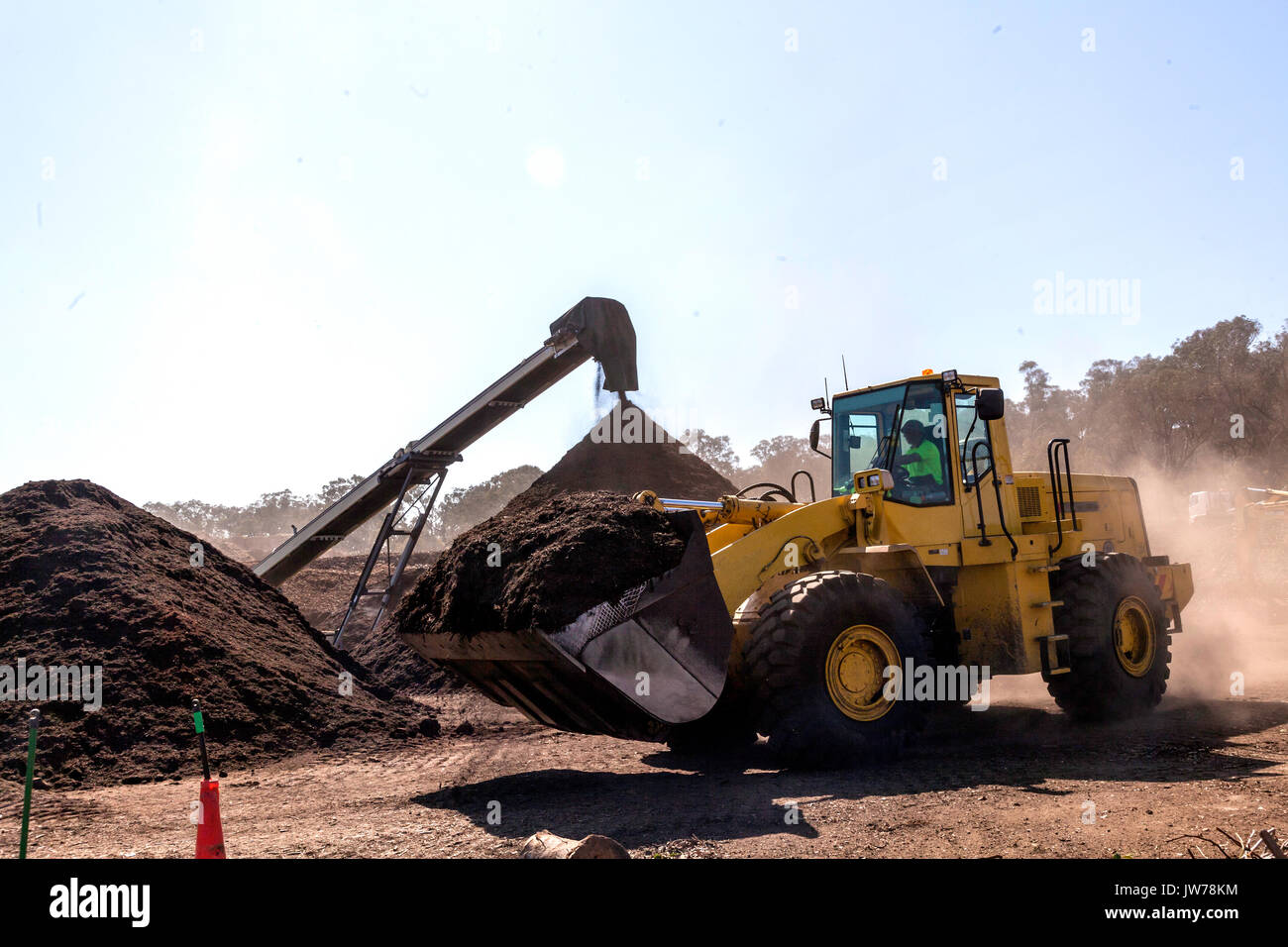 Front end loader moving compost Stock Photo - Alamy