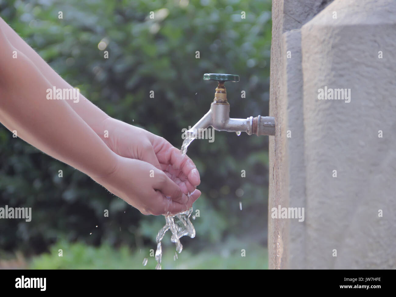 Woman washing hands outdoor Stock Photo - Alamy