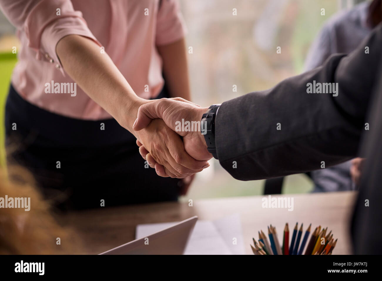 Male and female shaking hands on business deal Stock Photo - Alamy