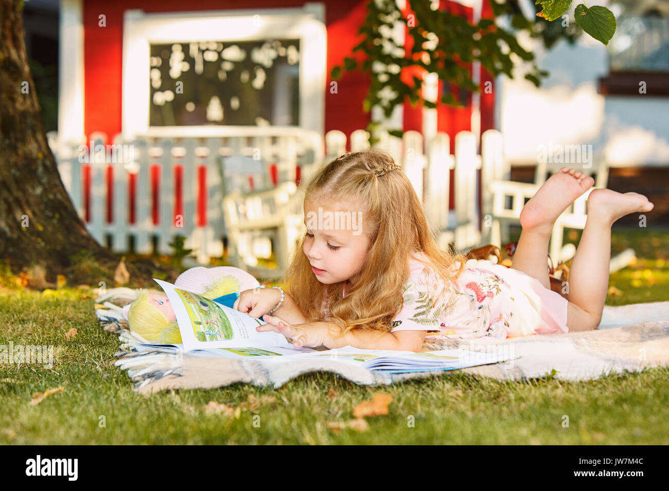 Little Girl Reading Outside