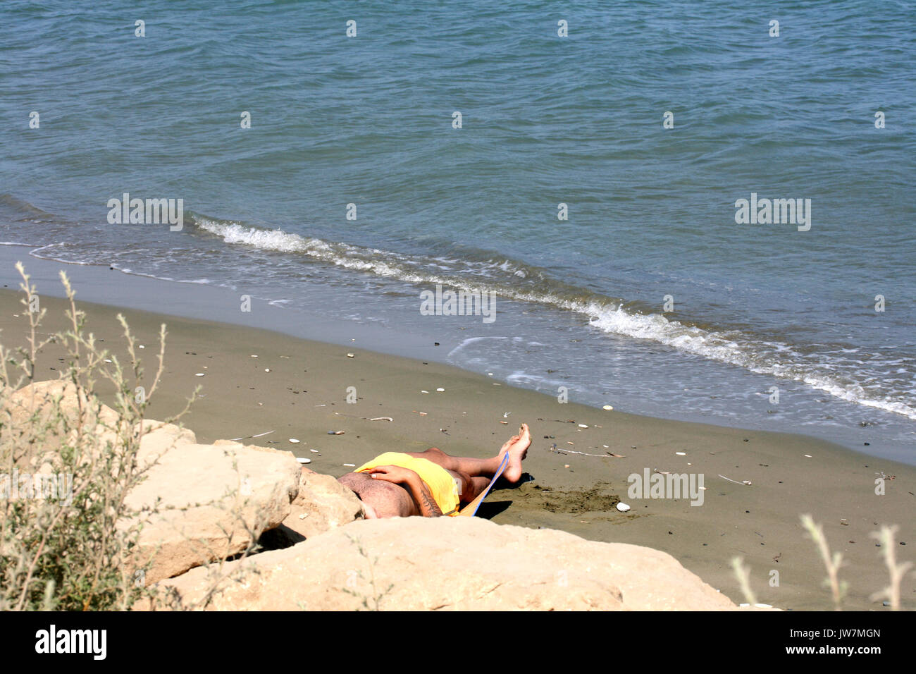Sunbather on Beach Stock Photo - Alamy