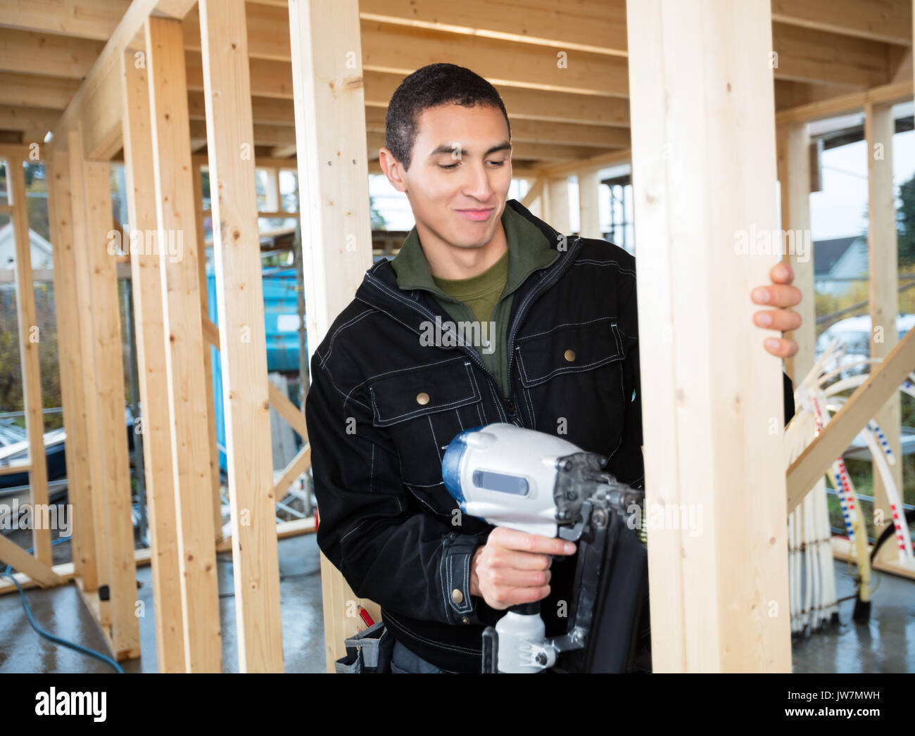 Construction worker using nail gun hi-res stock photography and images ...