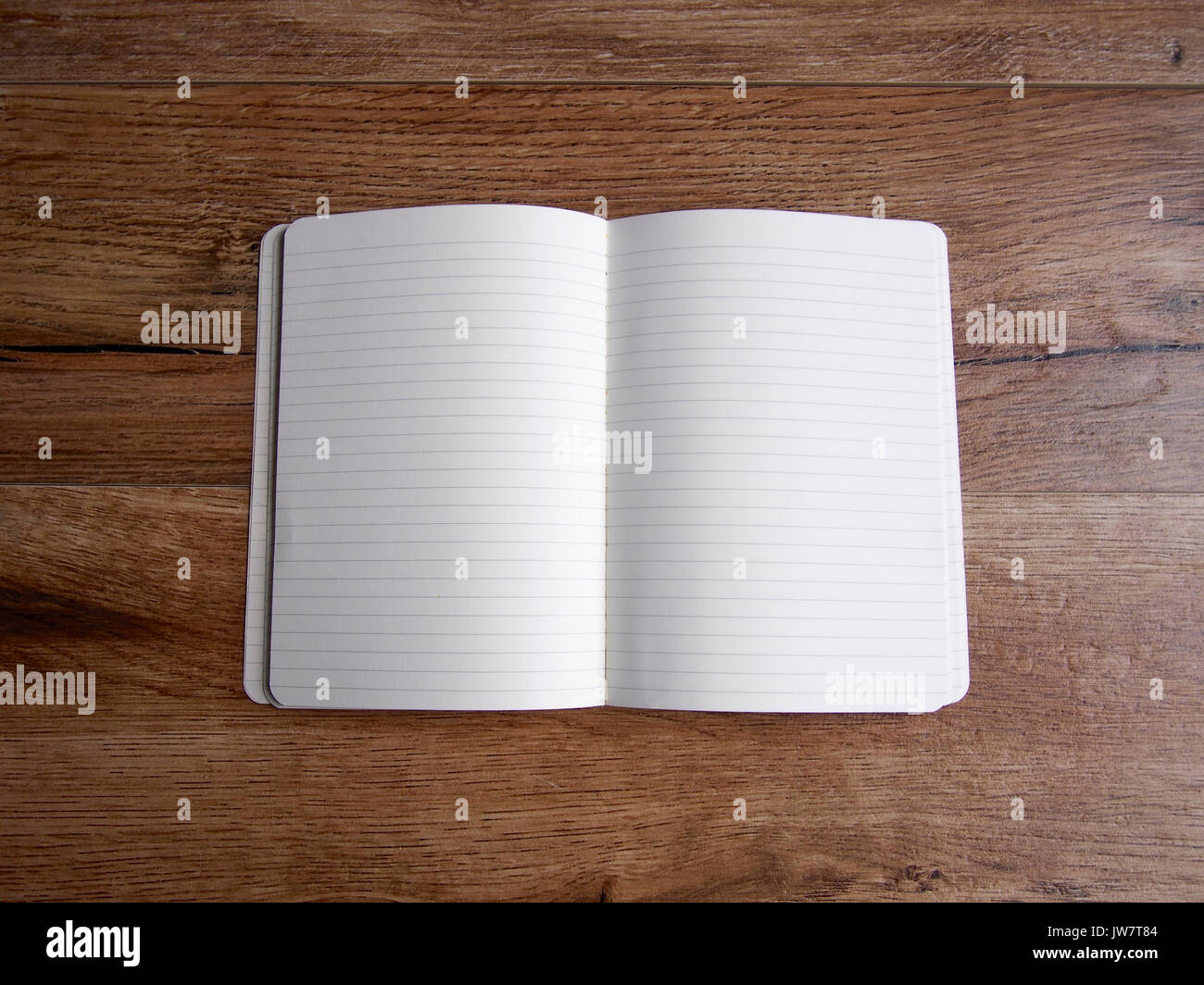 Open notebook on wood background Stock Photo - Alamy