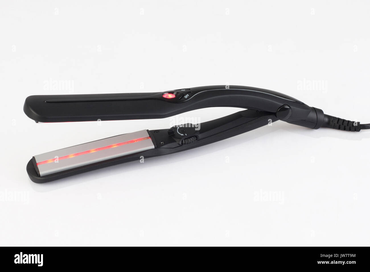 Hair straightener with red light isolated on white background Stock ...
