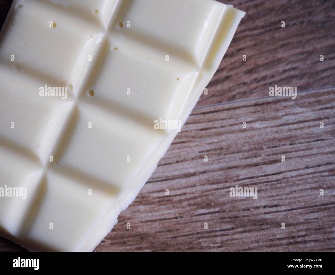 White chocolate on wood background Stock Photo - Alamy