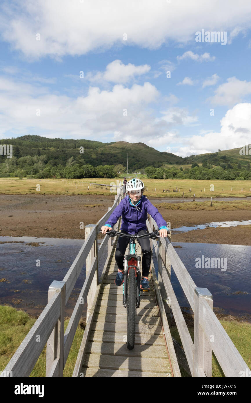Cycling across Jubilee bridge, Appin, Highland Scotland Stock Photo - Alamy