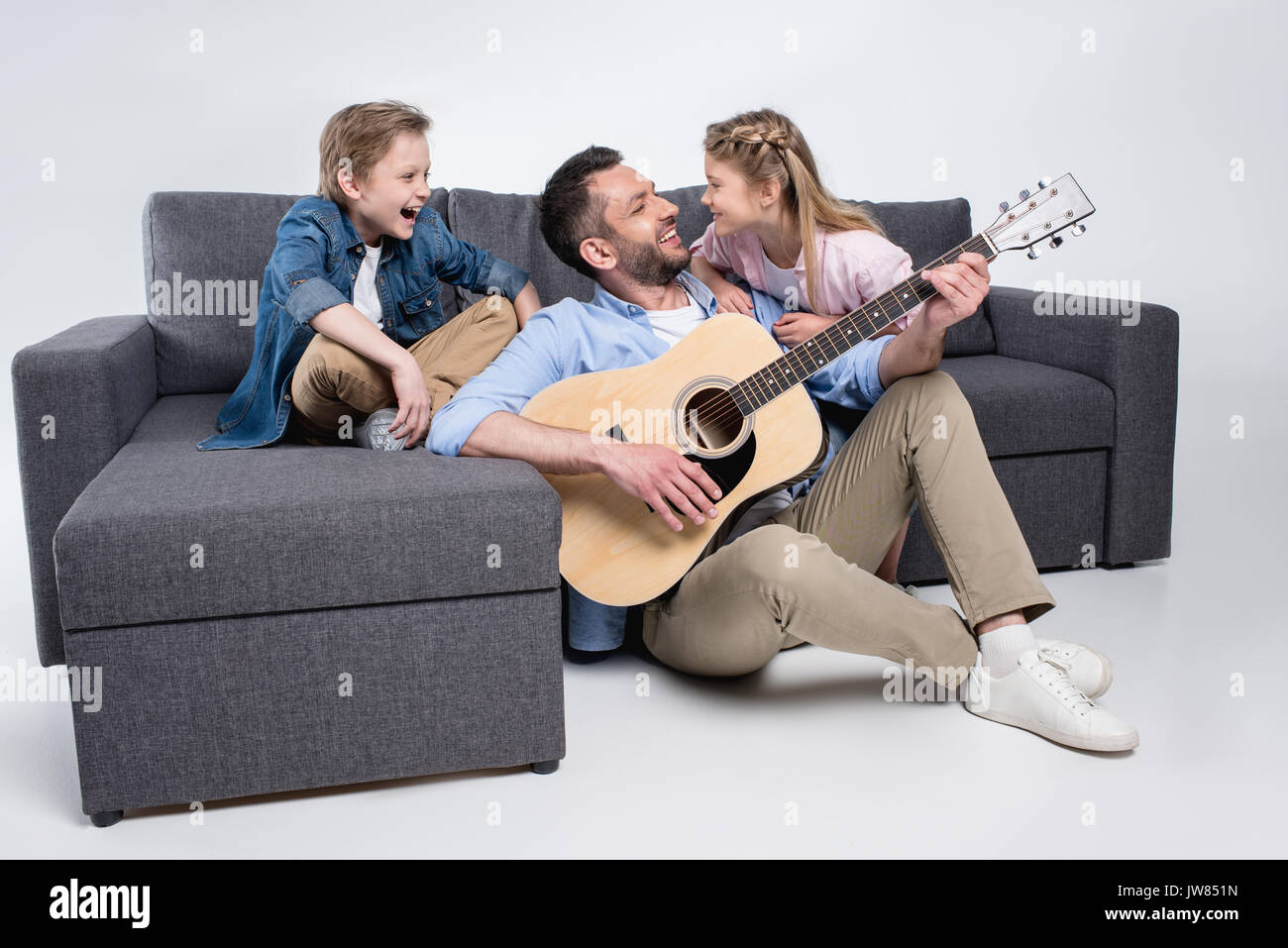 happy family playing on guitar and singing, spending time together ...