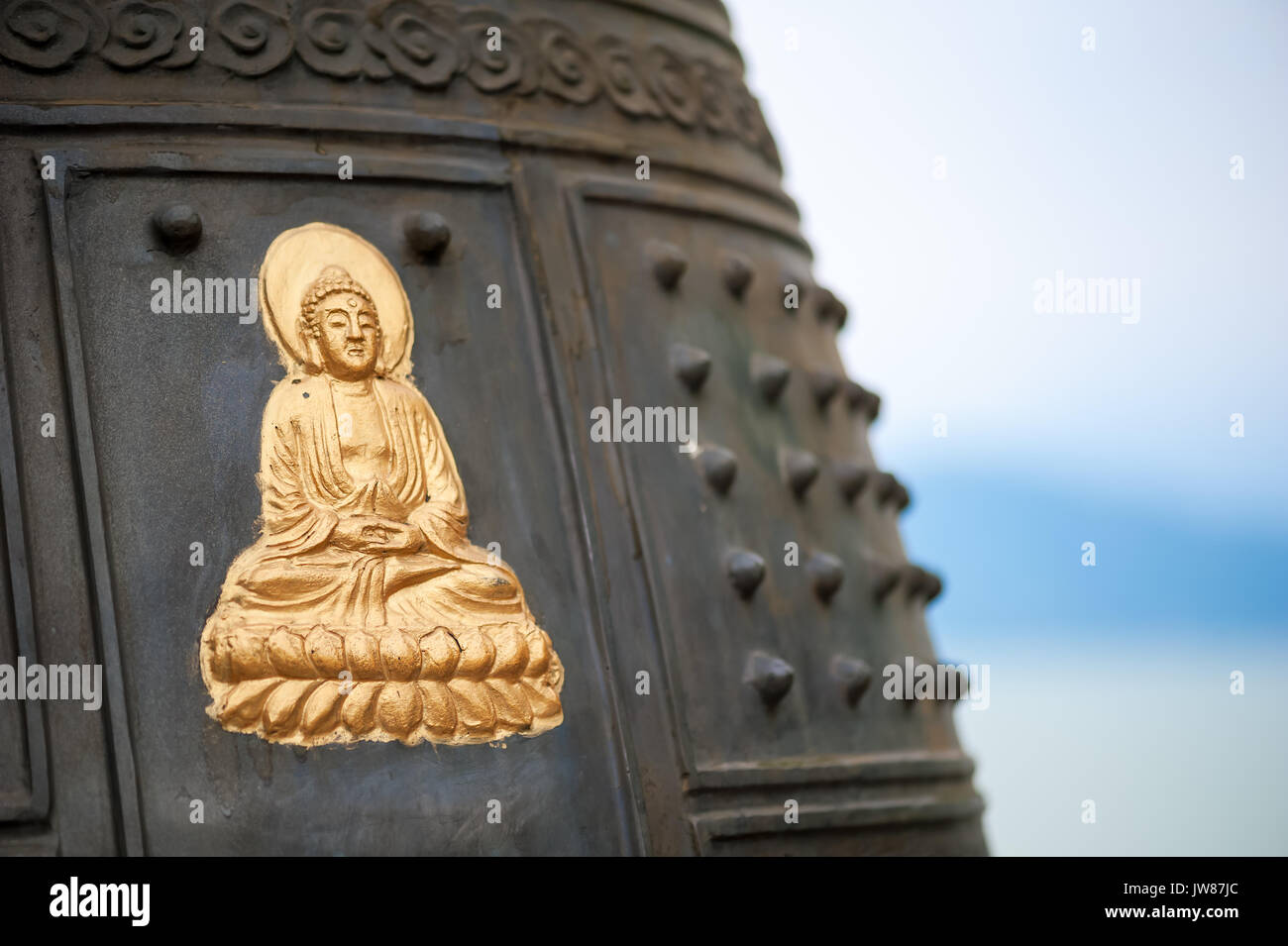 Golden colored Buddha on a ring bell in China Stock Photo - Alamy