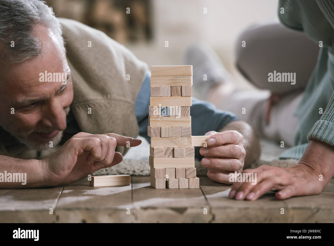 senior couple playing wood blocks game at home Stock Photo - Alamy