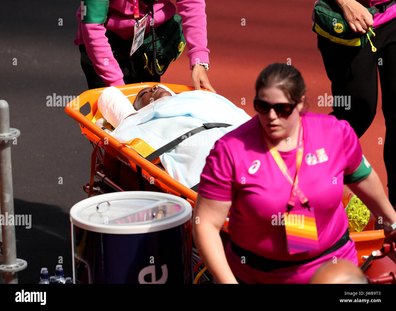 Trinidad and Tobago's Deborah John is removed from the track on a ...