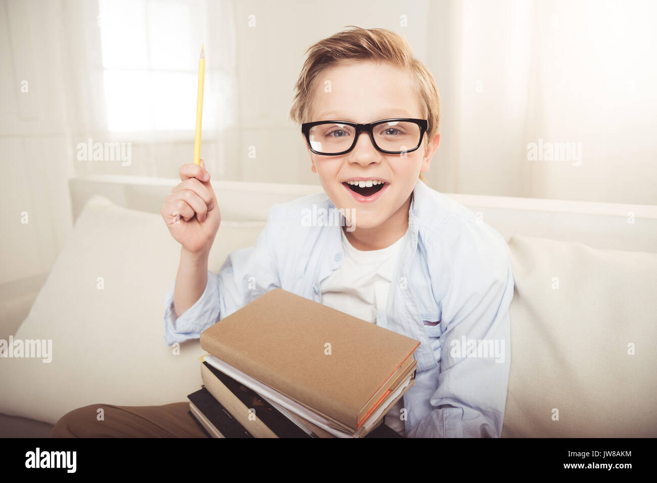 Child holding up pencil hi-res stock photography and images - Alamy