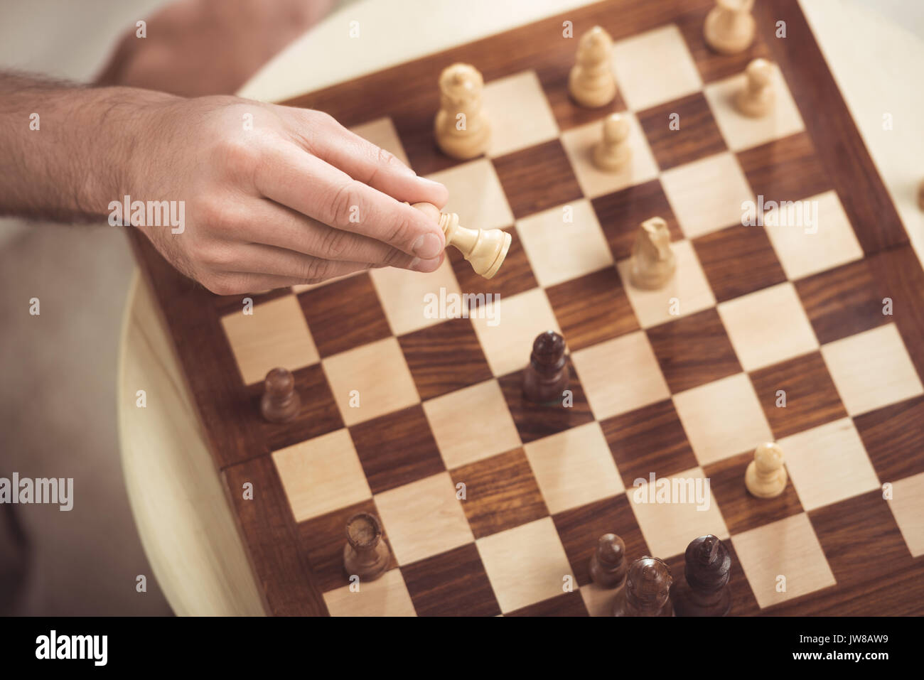 partial view of hand of chess player making a move of check mate during ...