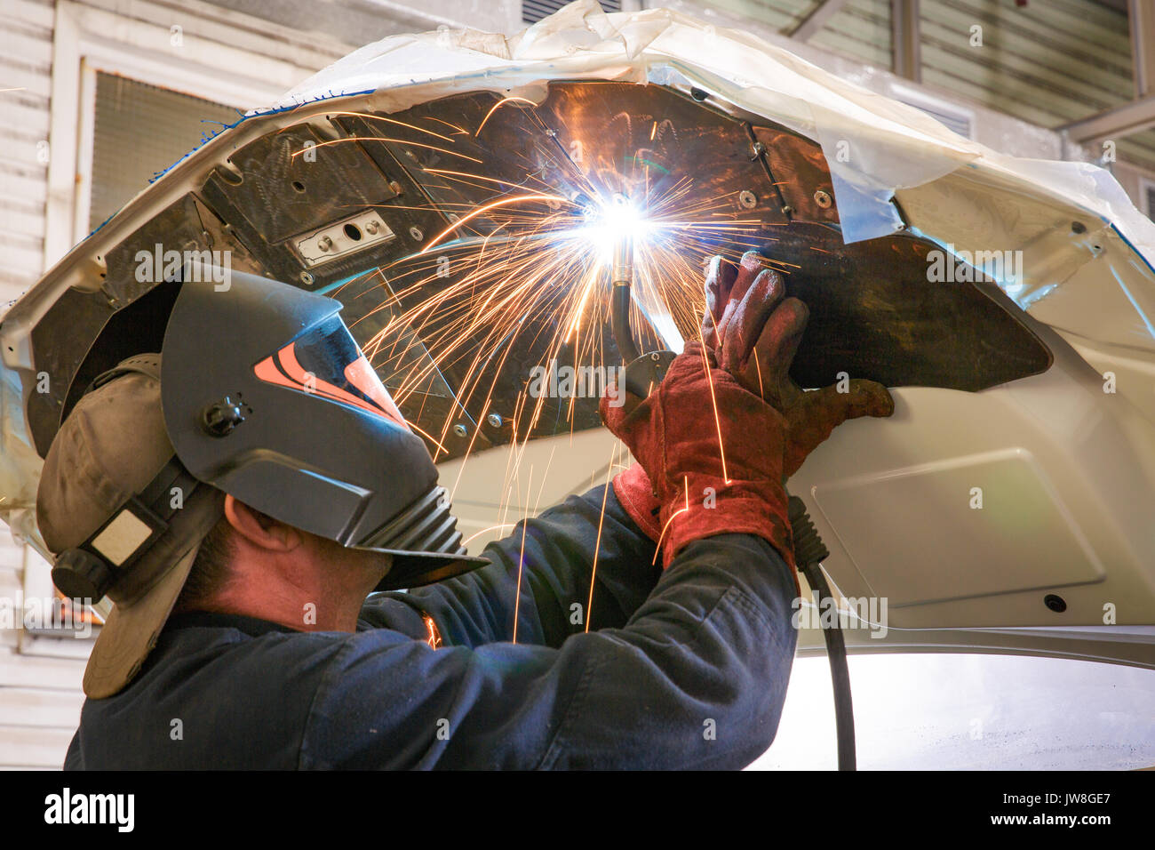 Male in face mask welds with argon-arc welding Stock Photo - Alamy