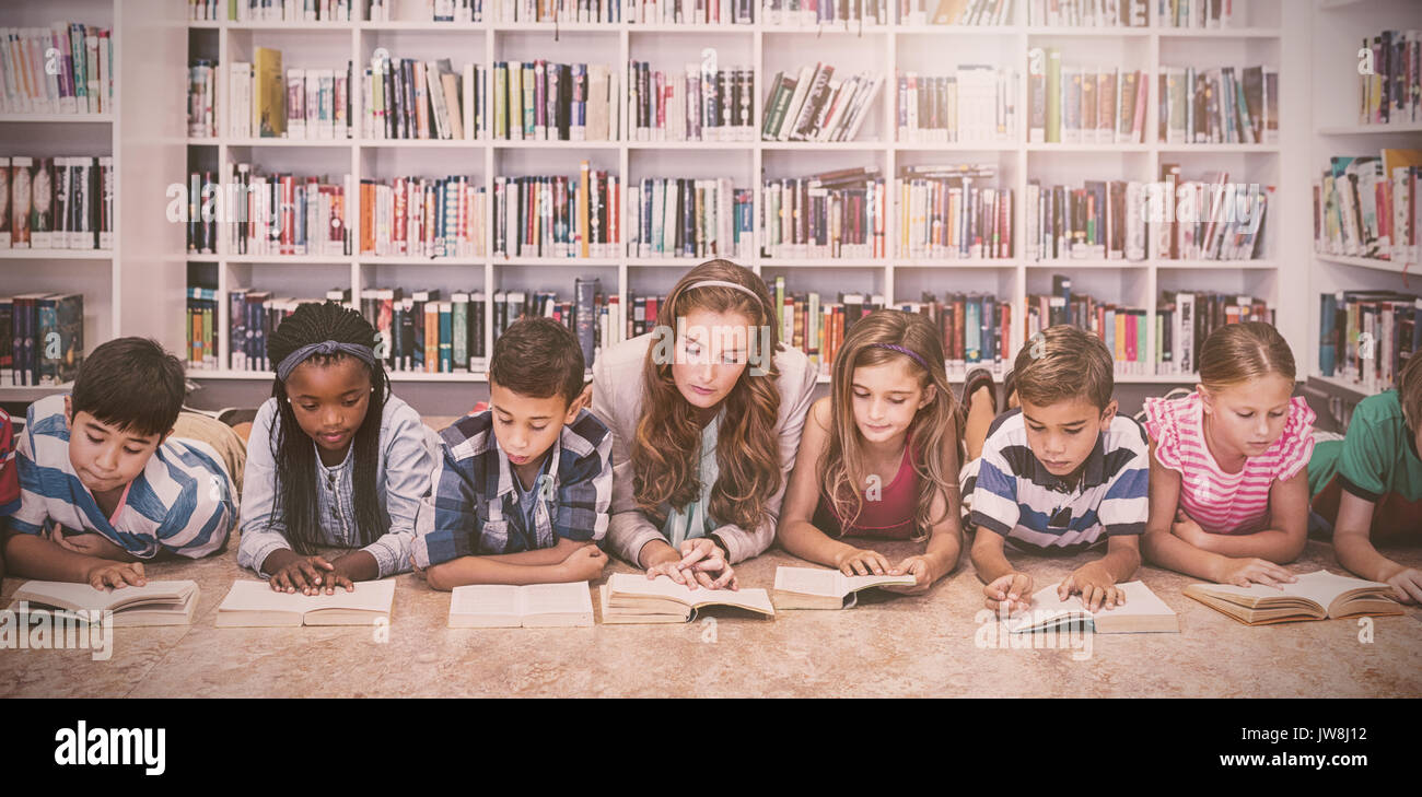 Teacher Reading Books To Her Students At School Stock Photo Alamy