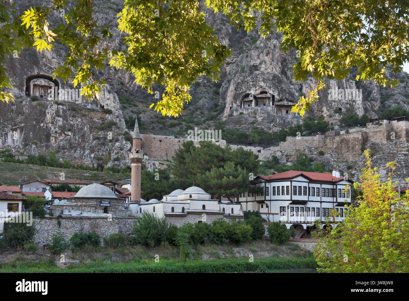 Old mosque and mansion , and rock tombs on the cliff seen between ...