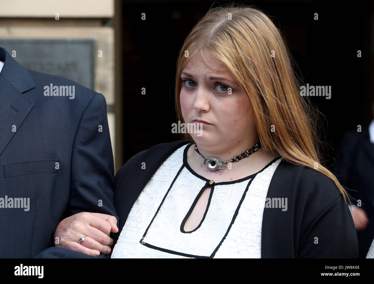 Rebecca Williams looks on as her father Phillip reads a statement on ...