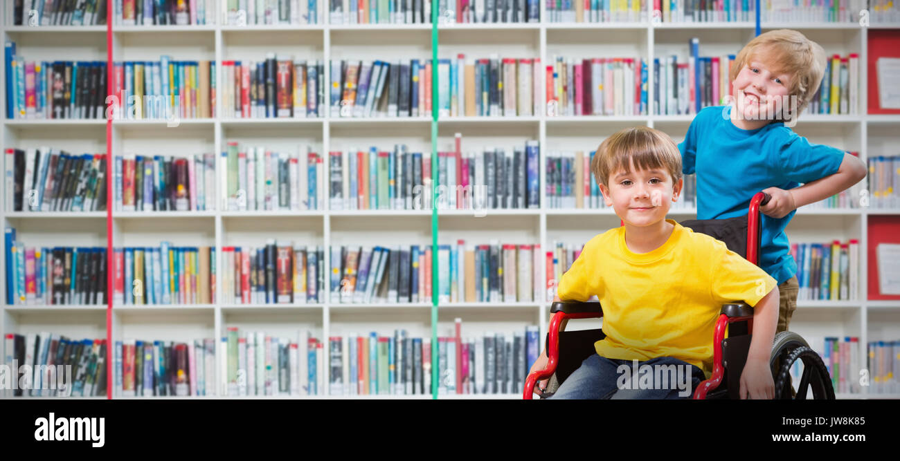 Happy boy pushing friend on wheelchair against multi colored bookshelf ...