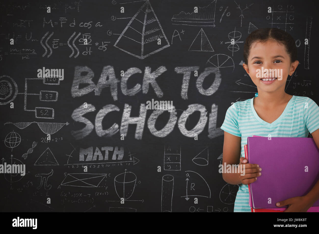 Portrait of smiling girl holding files against black background Stock ...