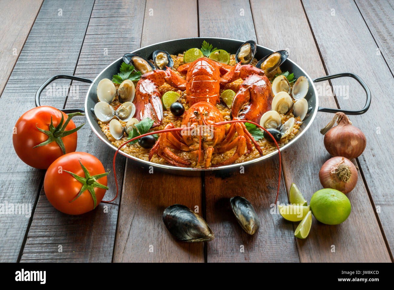 Gourmet seafood Valencia paella with fresh langoustine, clams, mussels ...