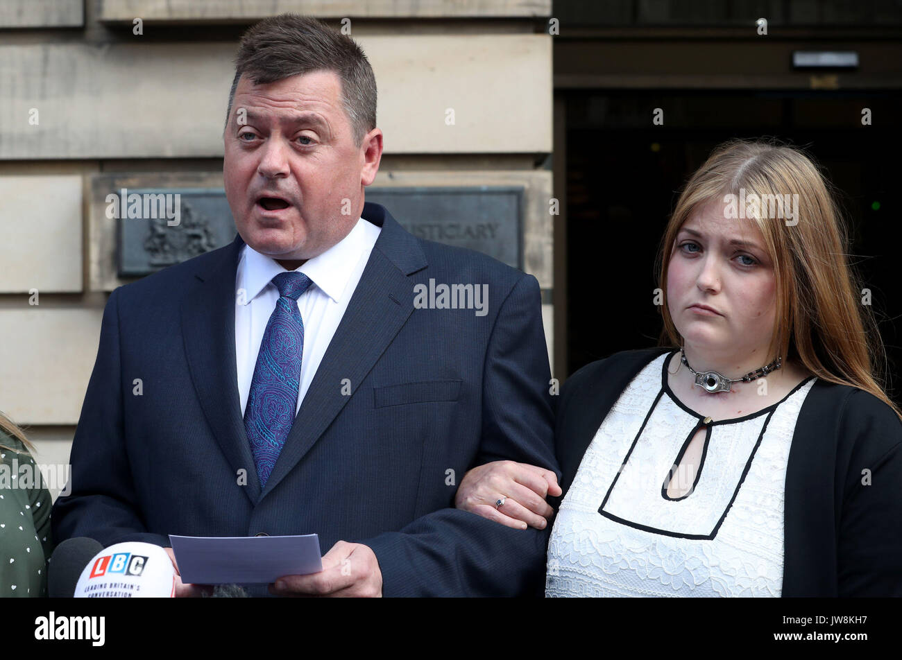 Rebecca Williams looks on as her father Phillip reads a statement on ...