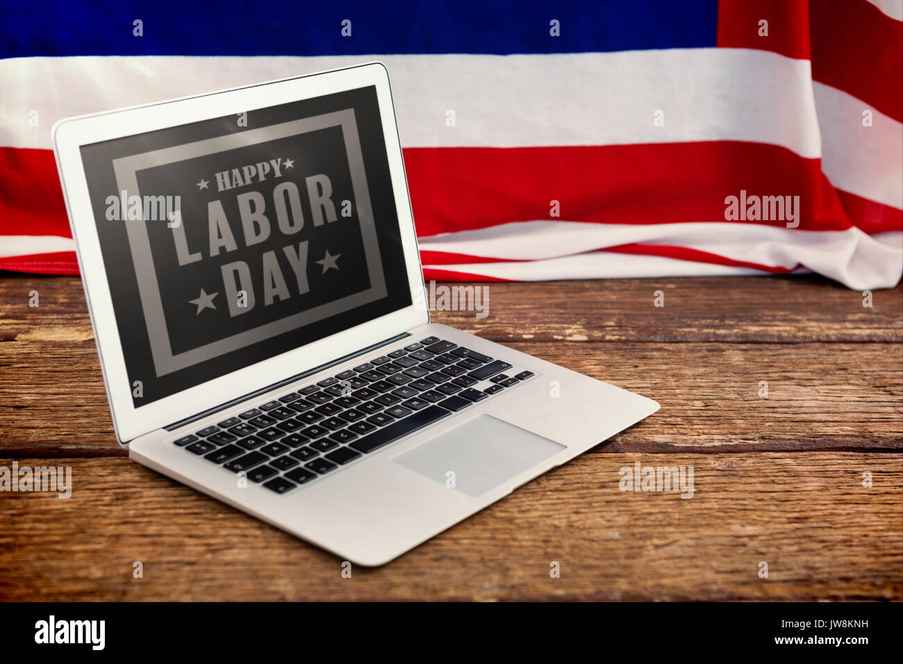 Flare against laptop and american flag on wooden table Stock Photo - Alamy