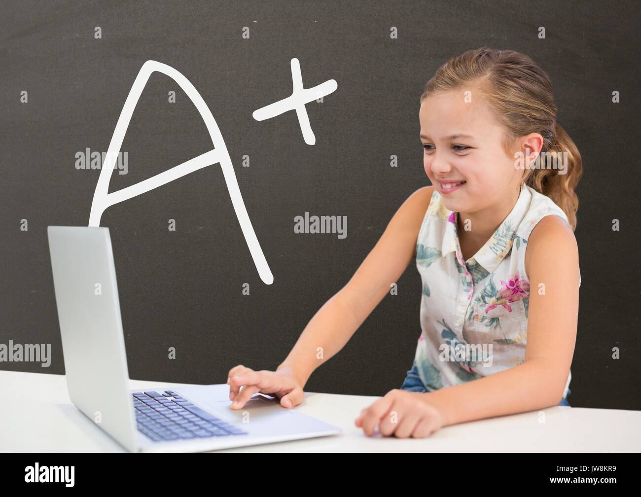 Digital composite of Happy student girl at table using a computer ...