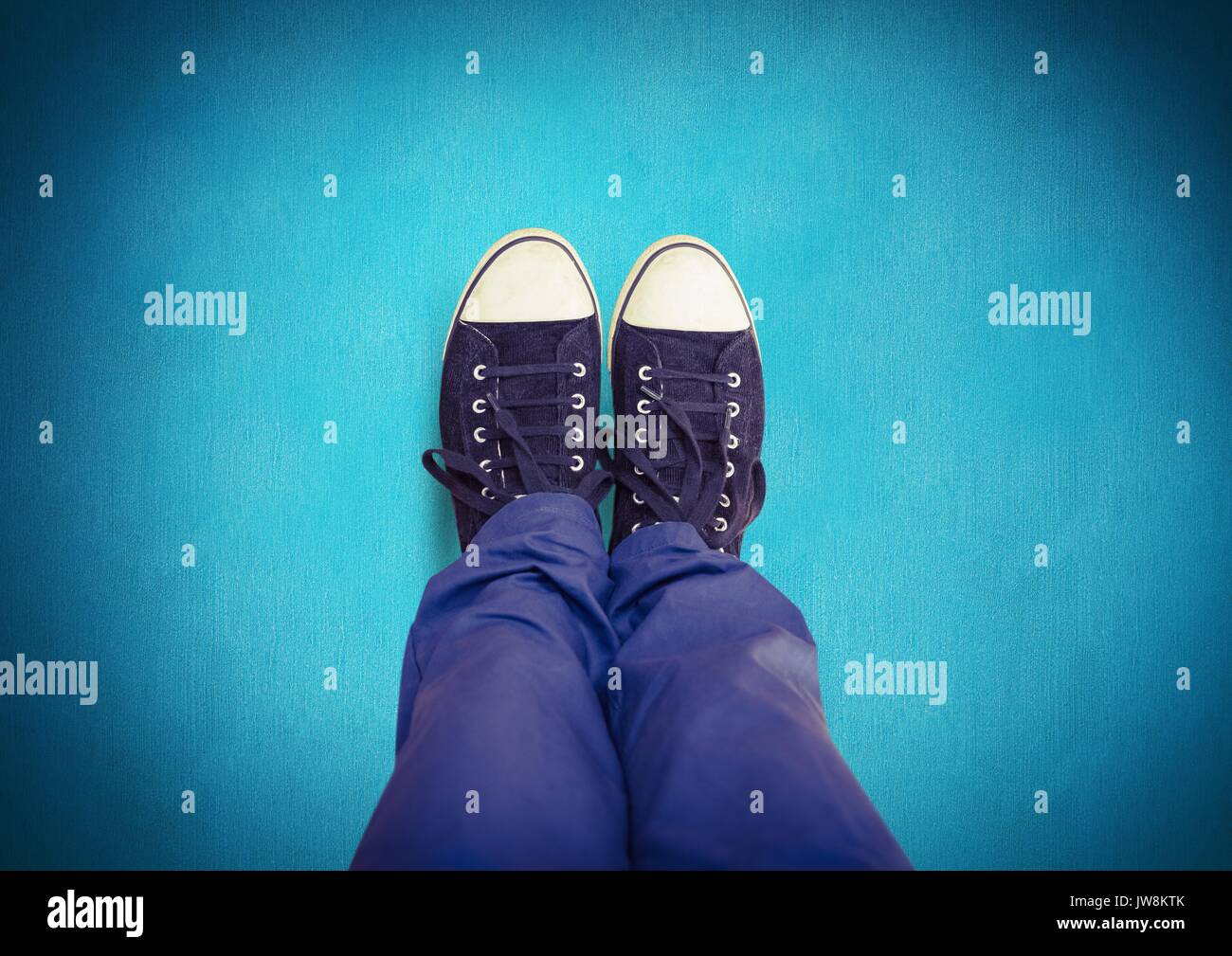 Digital composite of Black shoes on feet with blue background Stock ...