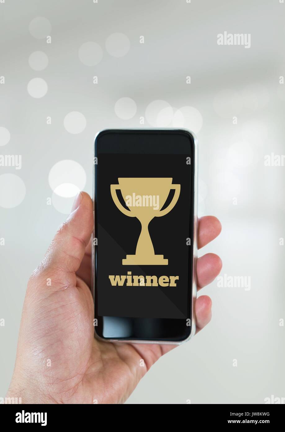 Digital composite of Person holding a phone with a trophy icon Stock ...