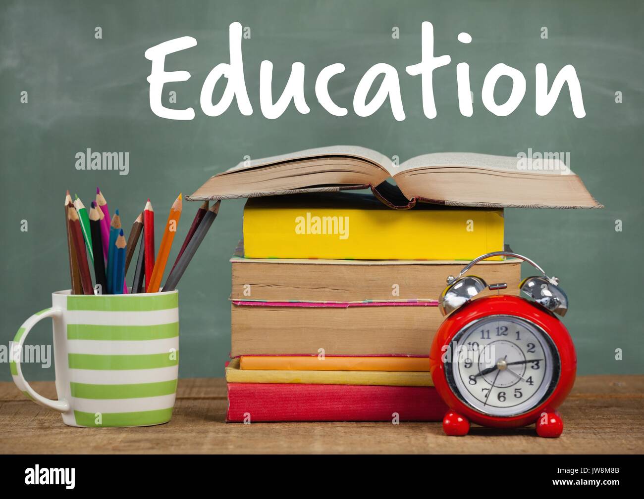Digital composite of Books on Desk foreground with blackboard Education ...