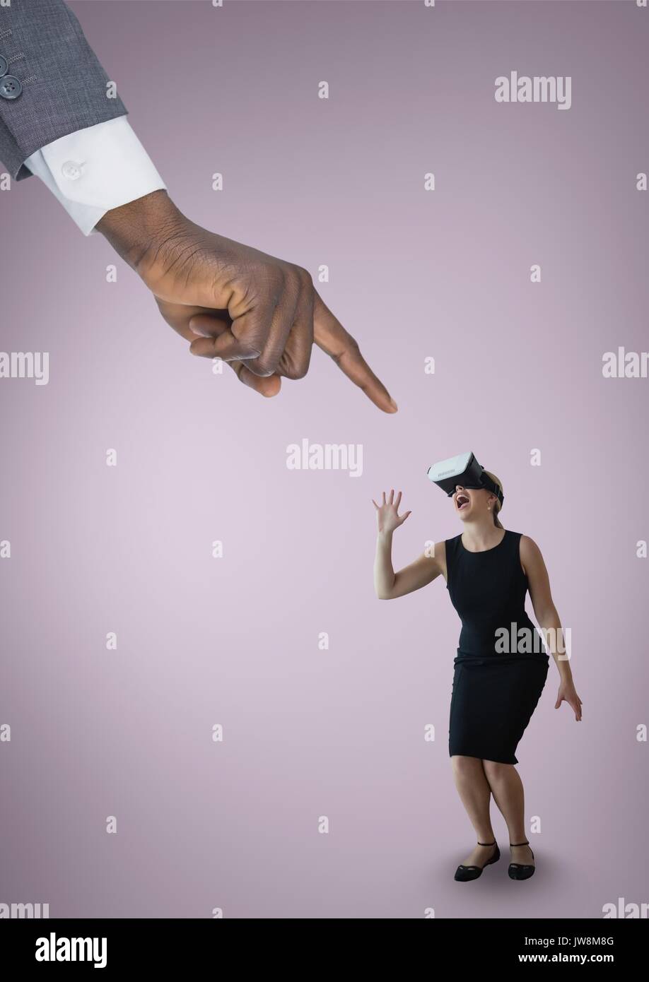 Digital composite of Hand pointing at scared business woman in VR ...