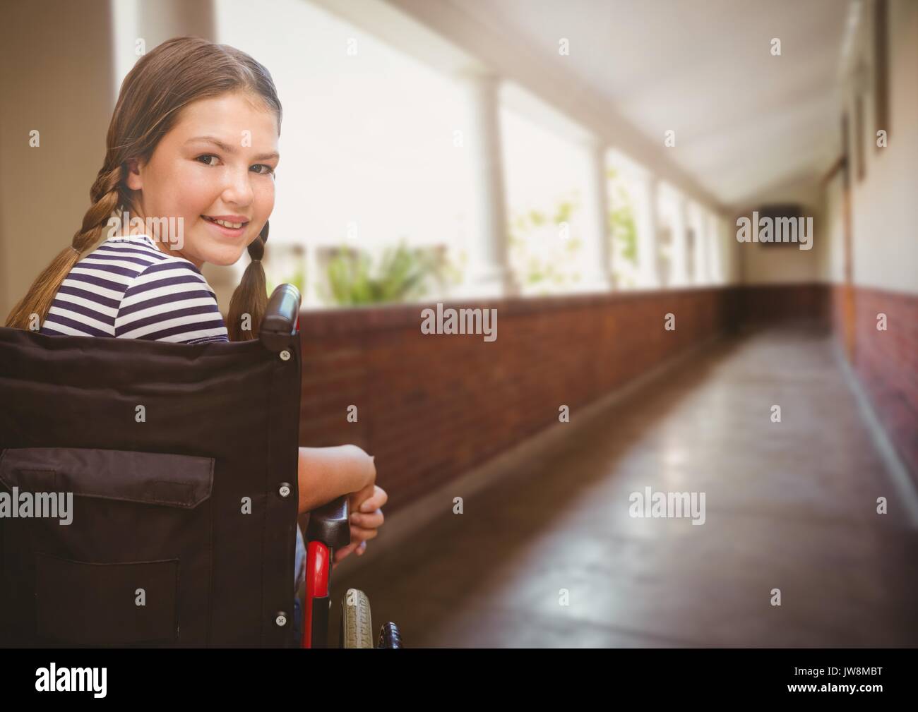 Digital composite of Disabled girl in wheelchair in school corridor ...