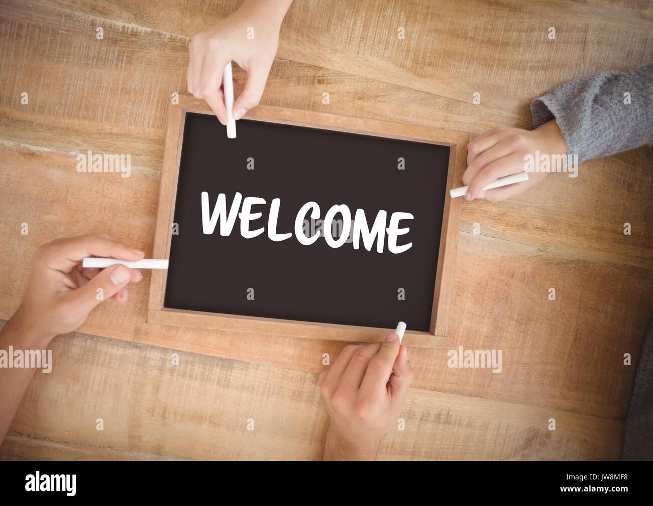Digital composite of Hands writing Welcome text on blackboard Stock ...