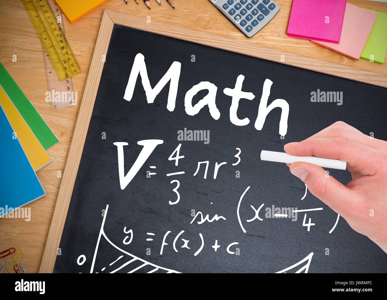 Digital composite of Math equations written on blackboard with chalk in ...