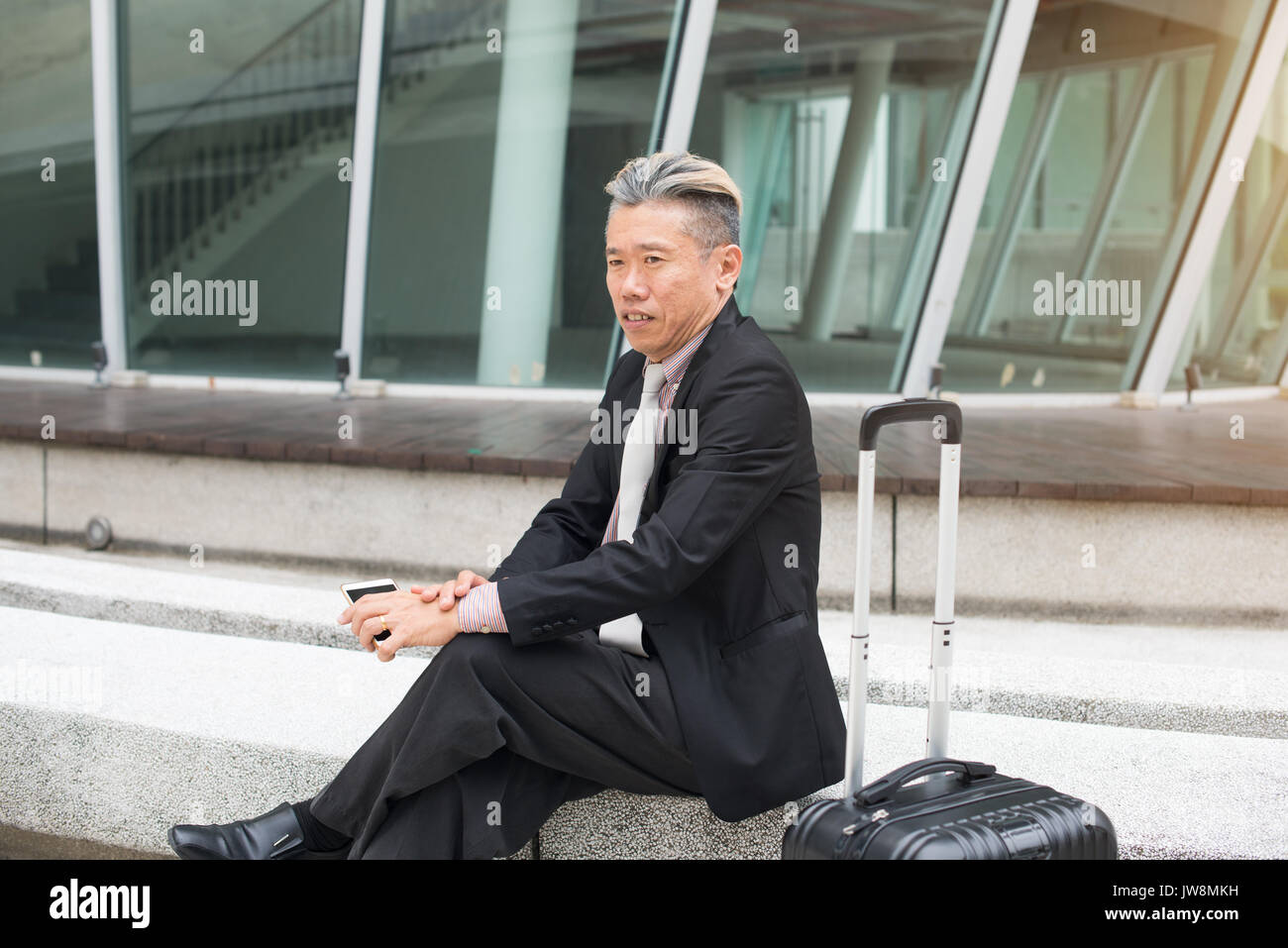 asian male sitting Stock Photo - Alamy