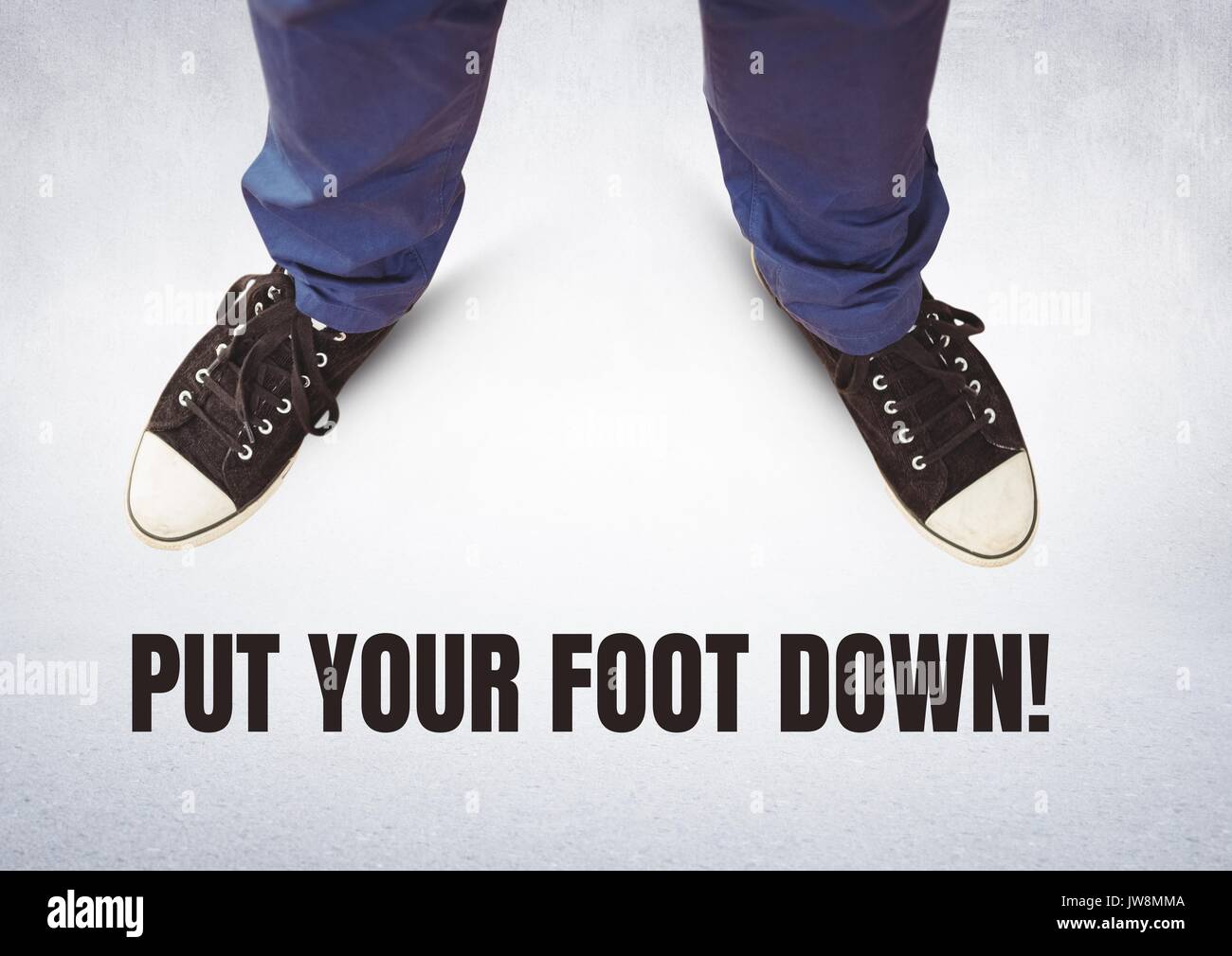 Digital composite of Put your foot down text and Black shoes on feet ...